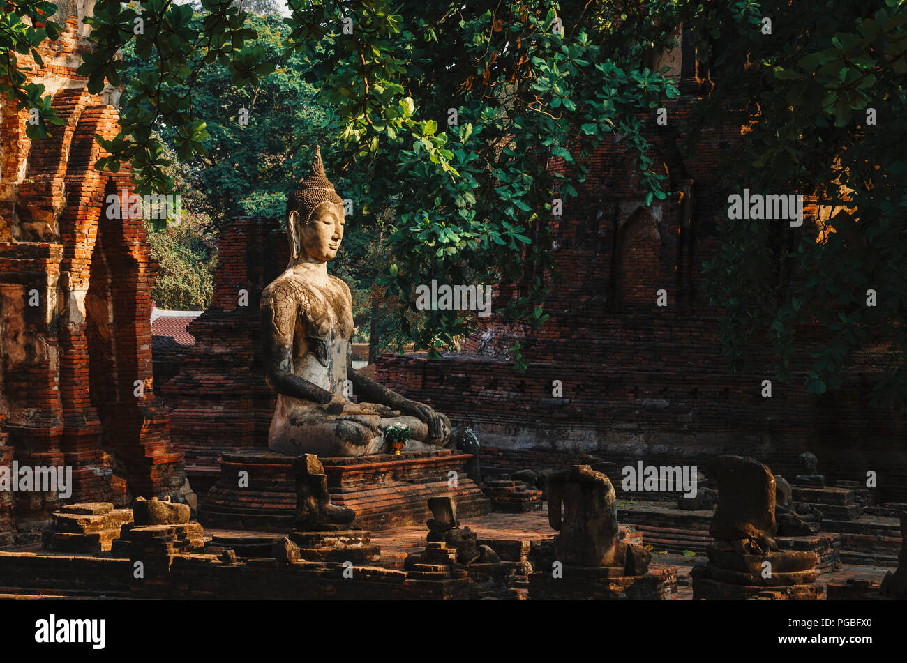 Carved stone Buddha statue; wat/temple complex in old Siam kingdom ...