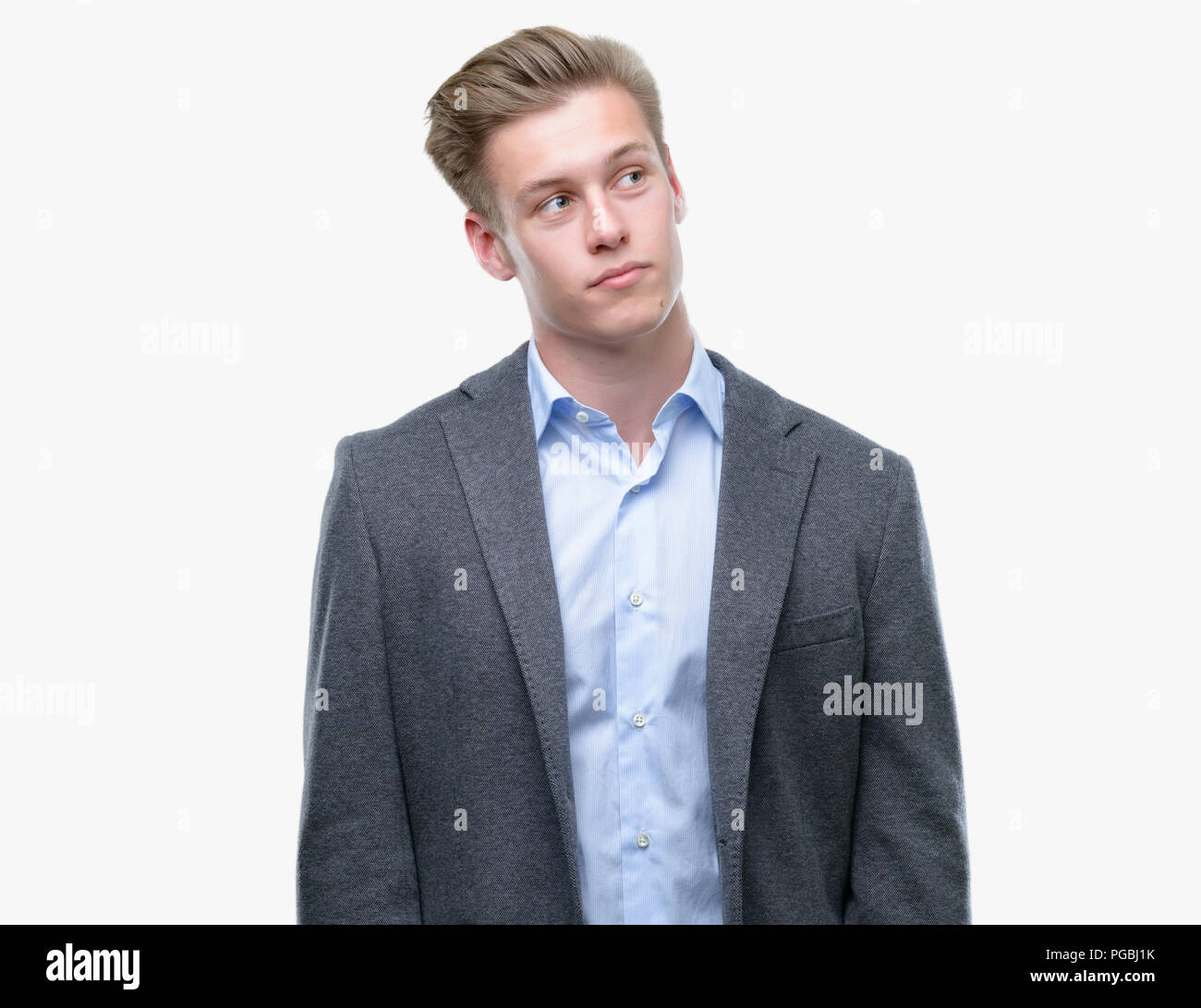 Young handsome blond business man smiling looking side and staring away ...