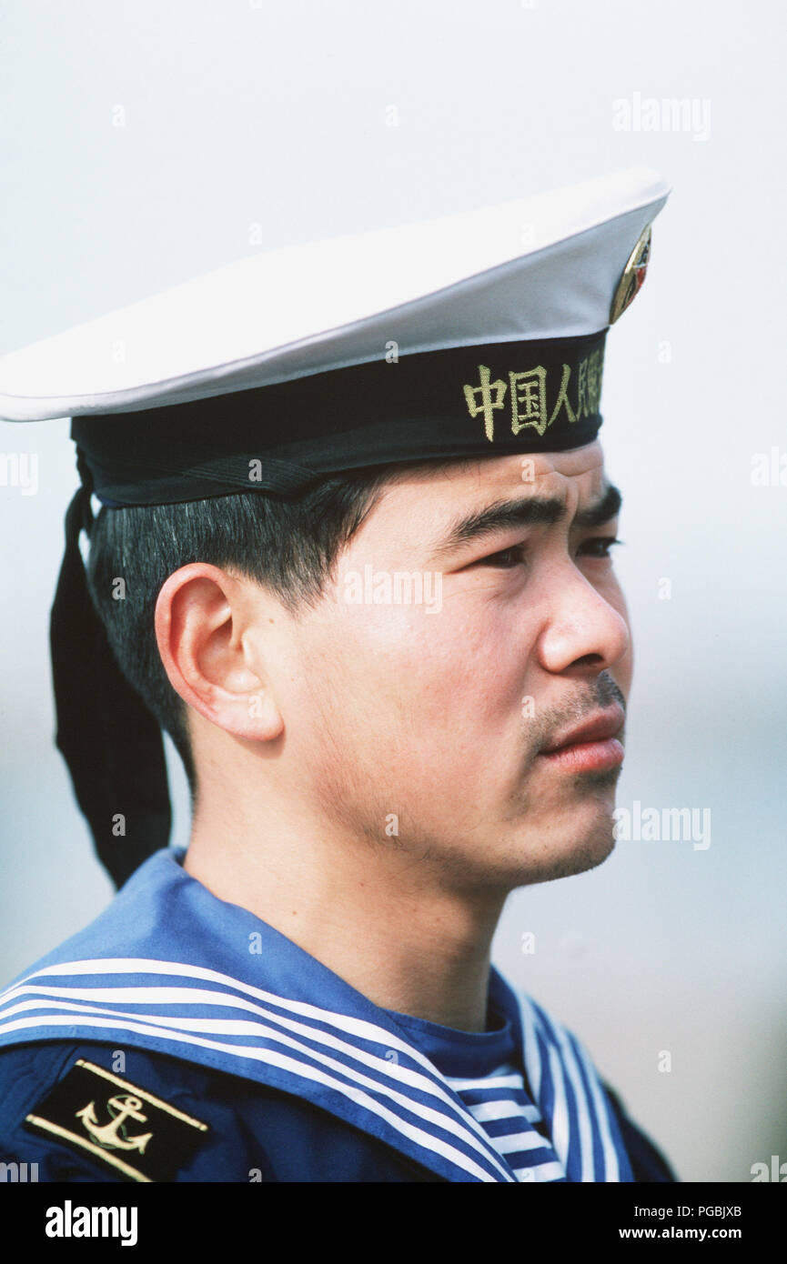 A Chinese sailor watches as US Navy (USN) ships arrive for the first ...