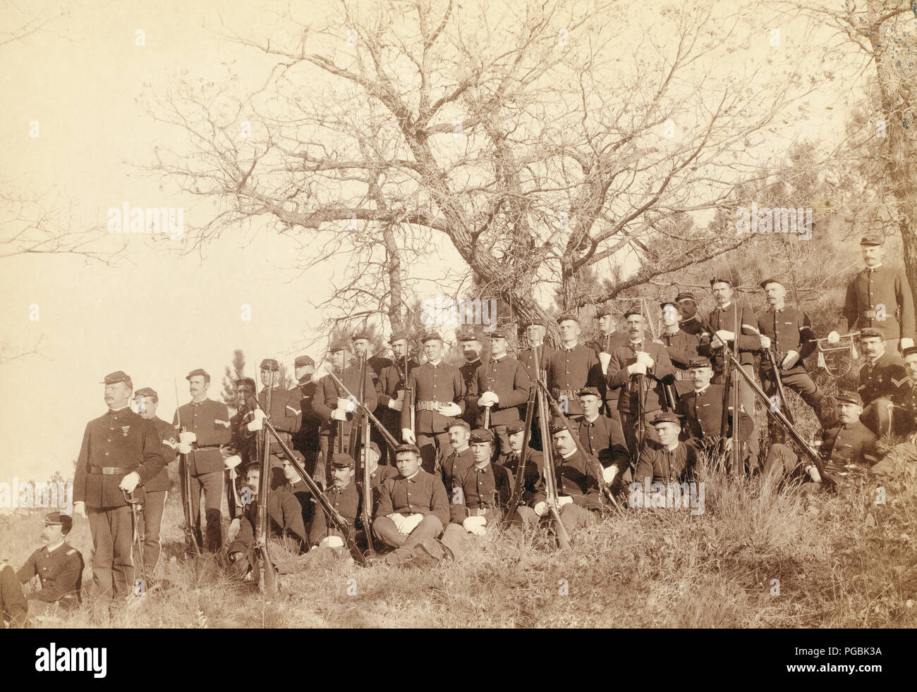 Group of uniformed military men, sitting and standing, posed with ...