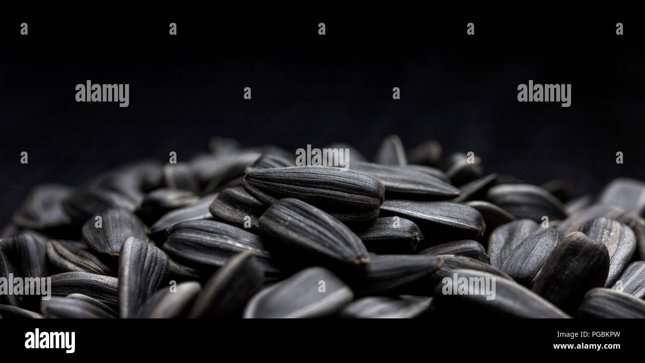 Sunflower seeds on black background. Copy space Stock Photo - Alamy