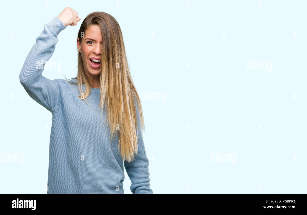 Beautiful young woman wearing sweater and jeans annoyed and frustrated ...