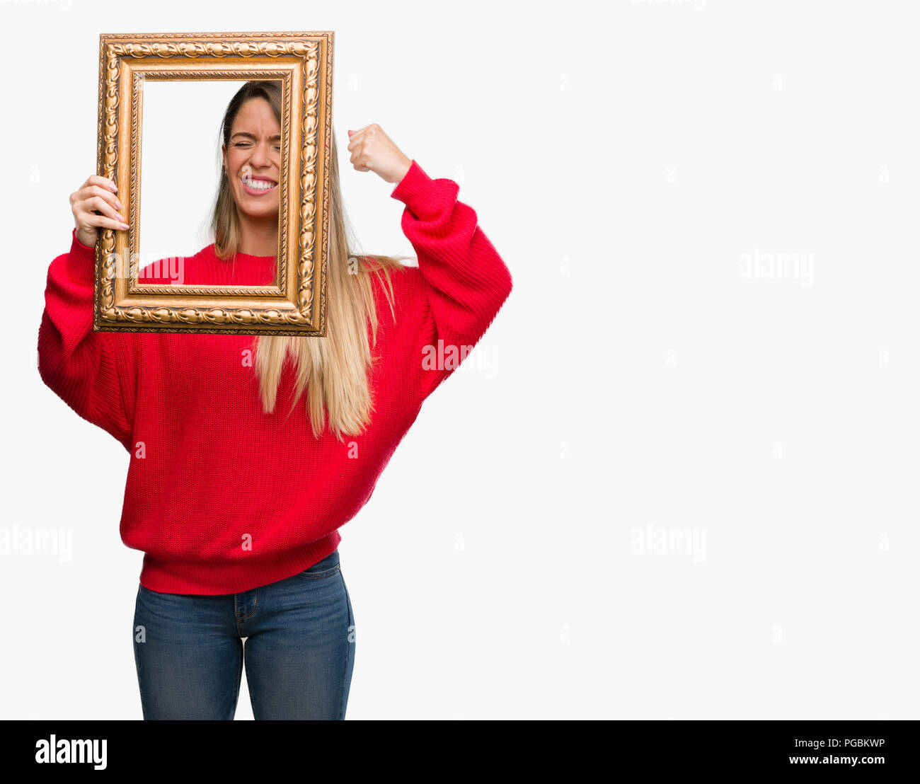 Beautiful young woman holding vintage frame annoyed and frustrated ...