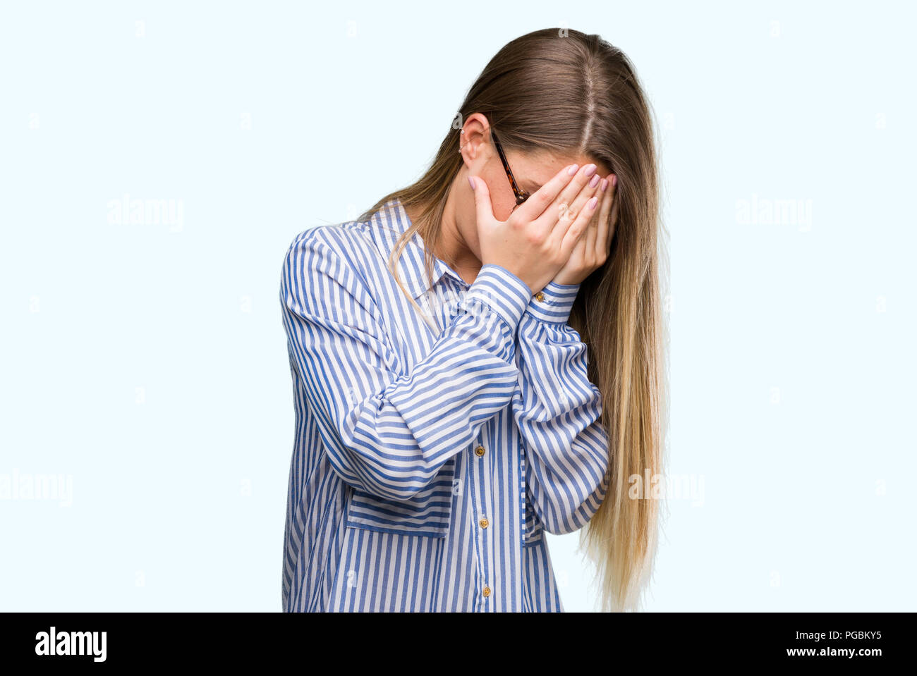 Beautiful young woman wearing elegant shirt and glasses with sad ...