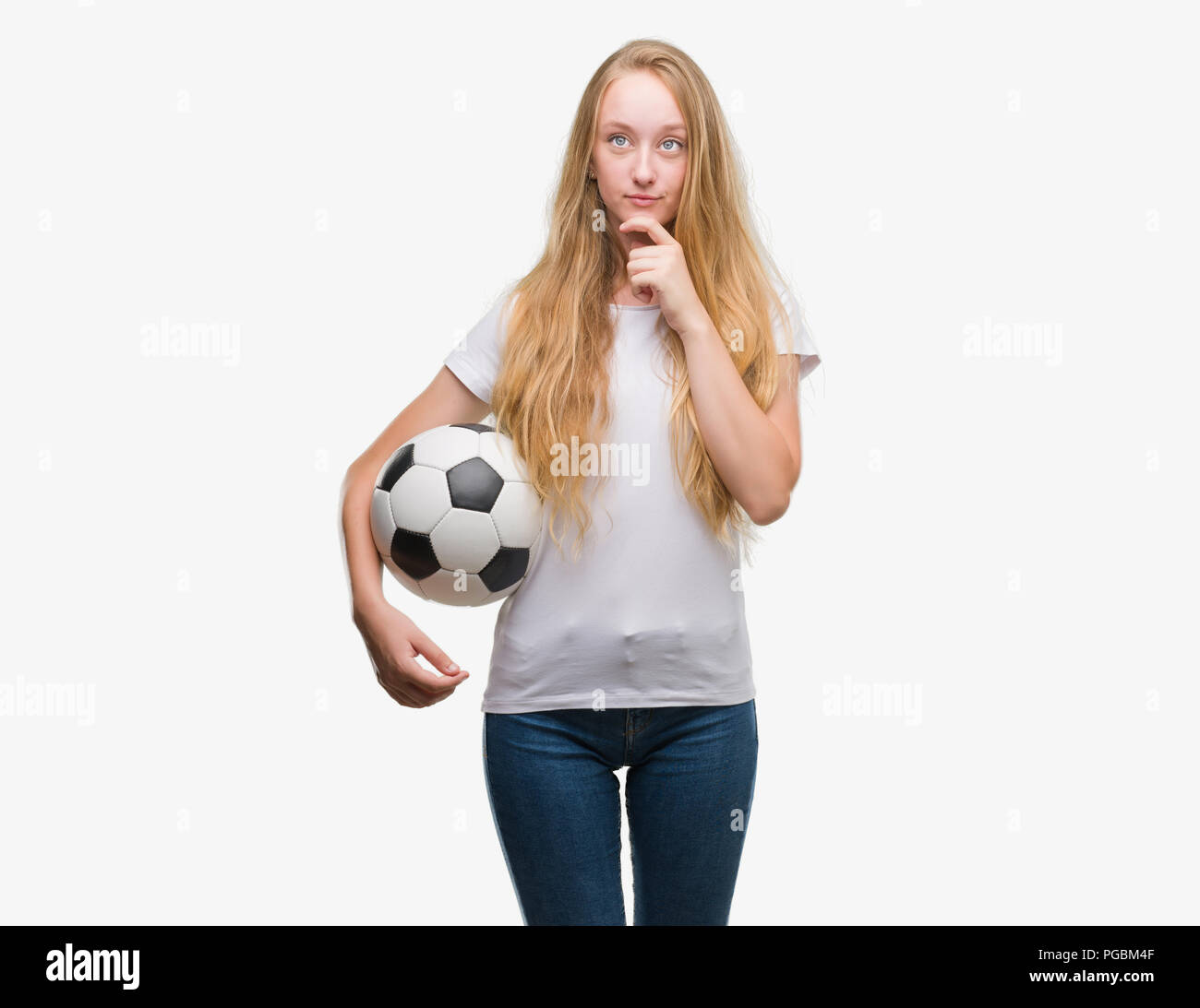 Blonde teenager woman holding soccer football ball serious face ...