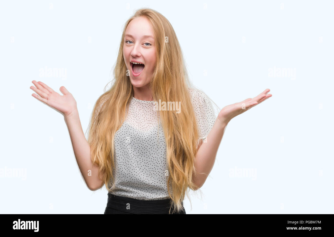 Blonde teenager woman wearing moles shirt celebrating crazy and amazed ...