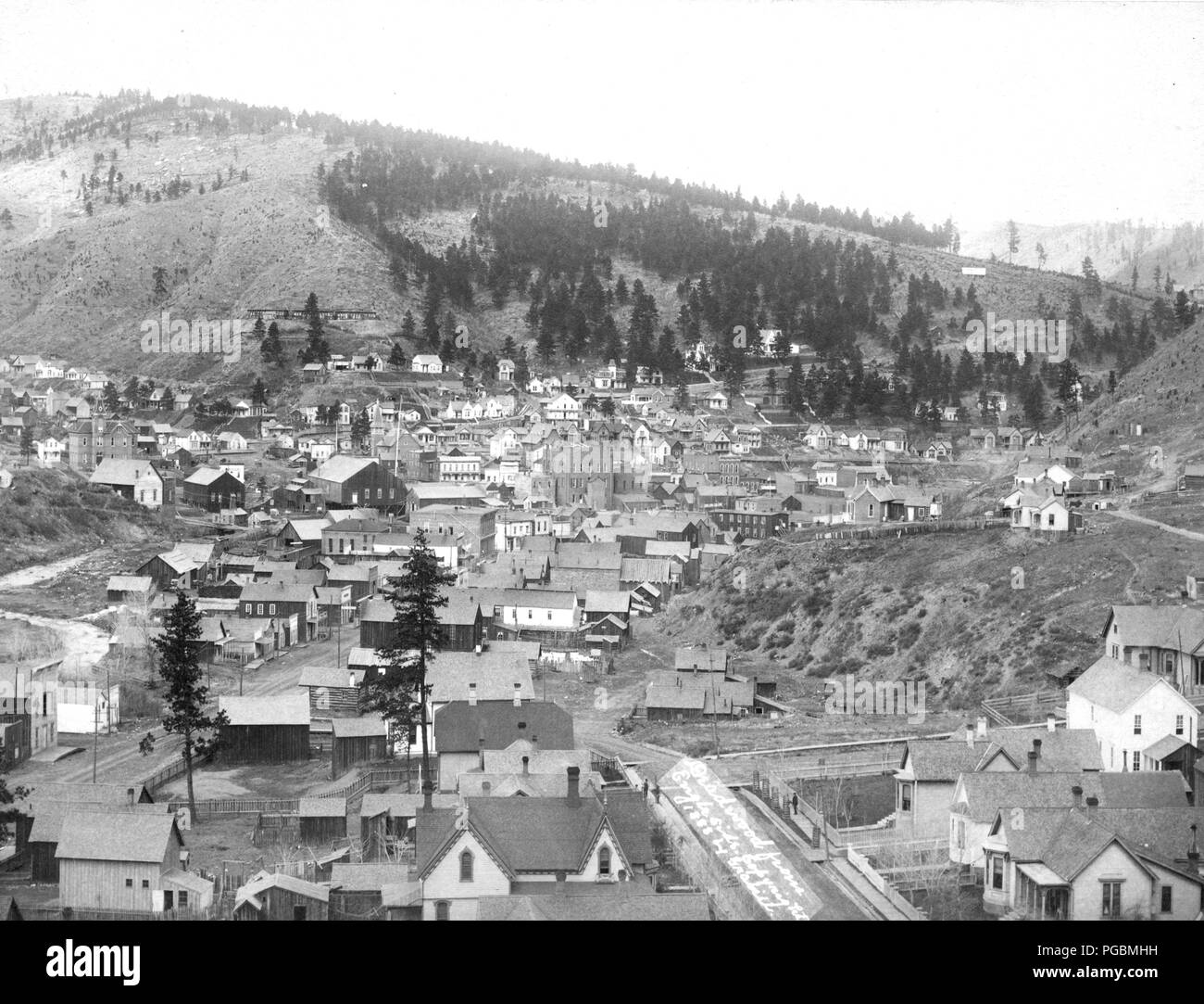 Overview of homes and commercial buildings in small city; trees and ...