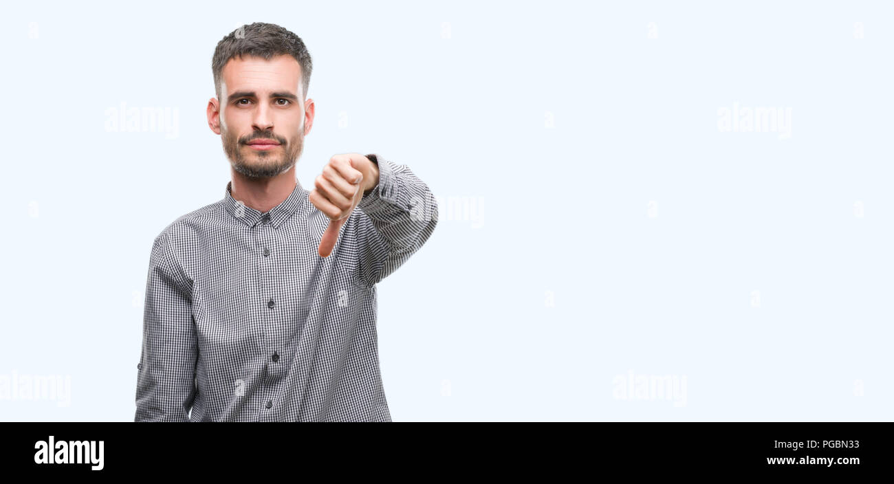 Young hipster man looking unhappy and angry showing rejection and ...