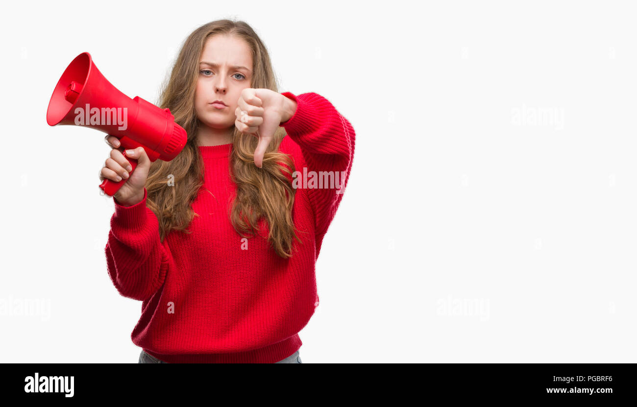 Young blonde woman holding red megaphone with angry face, negative sign ...