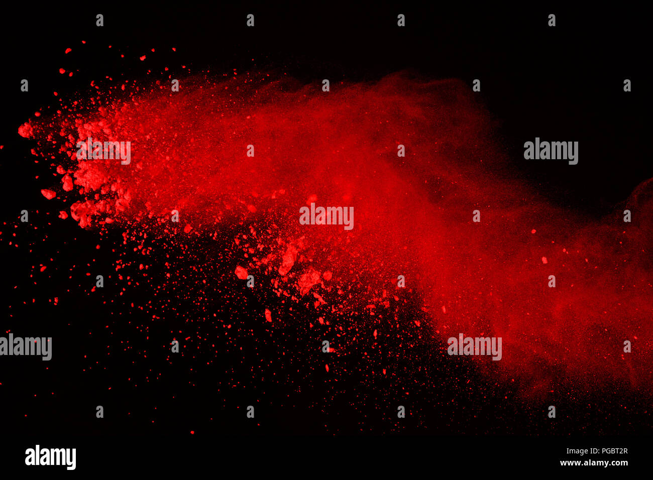 Abstract of red powder explosion on black background. Red powder ...