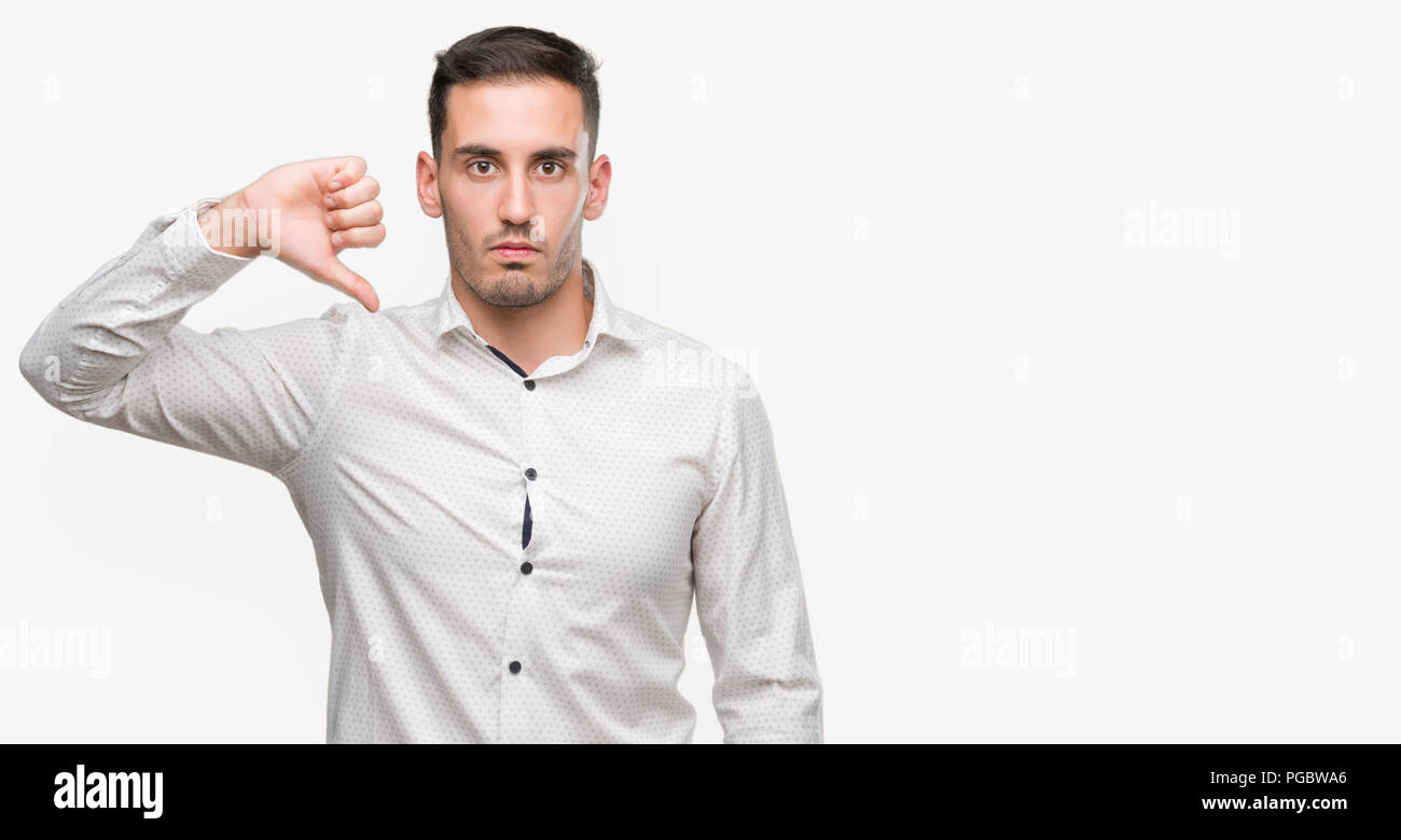 Handsome young business man with angry face, negative sign showing ...