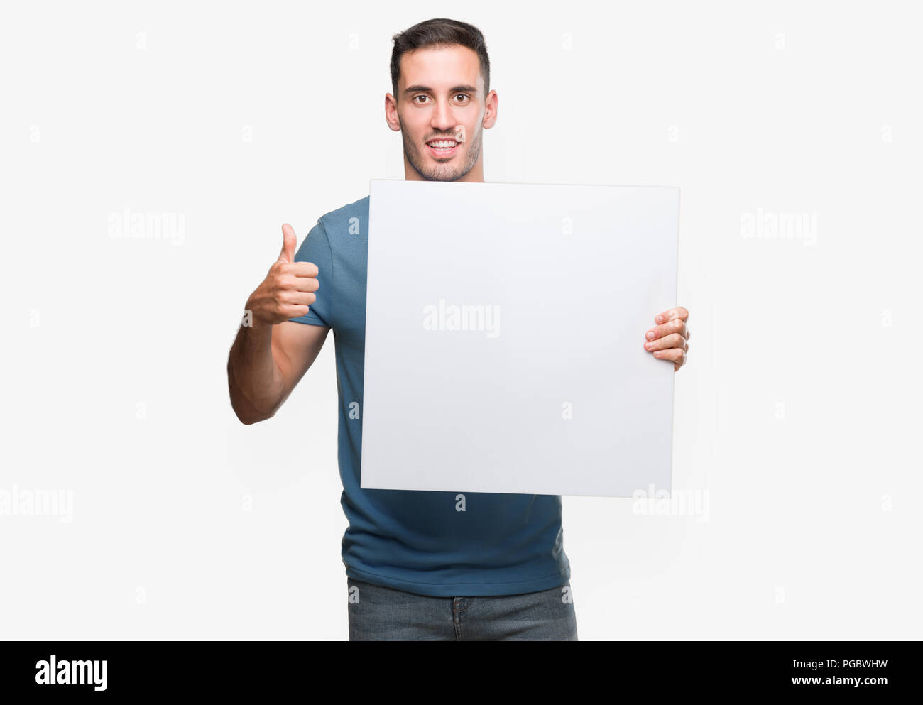 Handsome young man holding advertising banner happy with big smile ...
