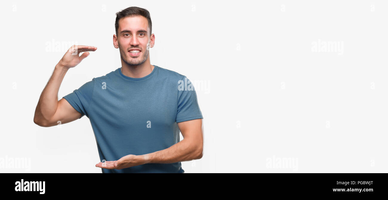Handsome young casual man gesturing with hands showing big and large ...