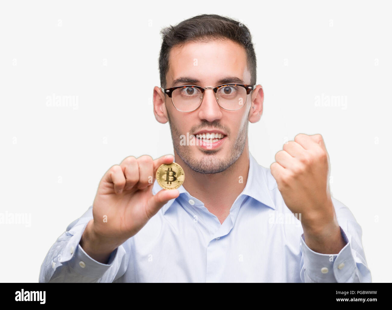 Handsome young man holding bitcoin screaming proud and celebrating ...