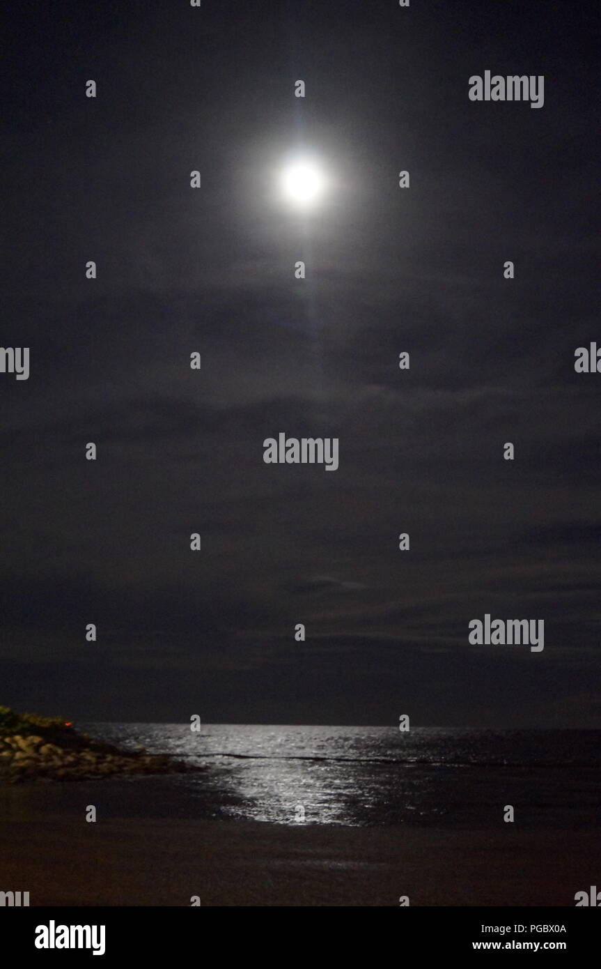 Moon reflection over the ocean on a summer night at a Caribbean Island ...
