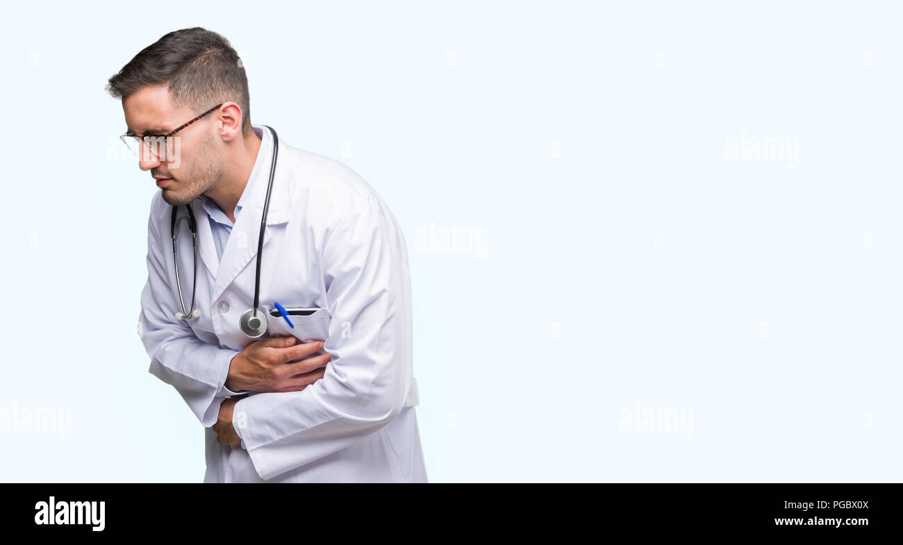 Handsome young doctor man with hand on stomach because nausea, painful ...