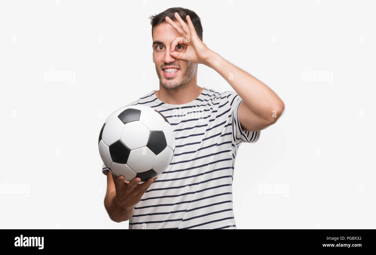 Handsome young man holding soccer football with happy face smiling ...
