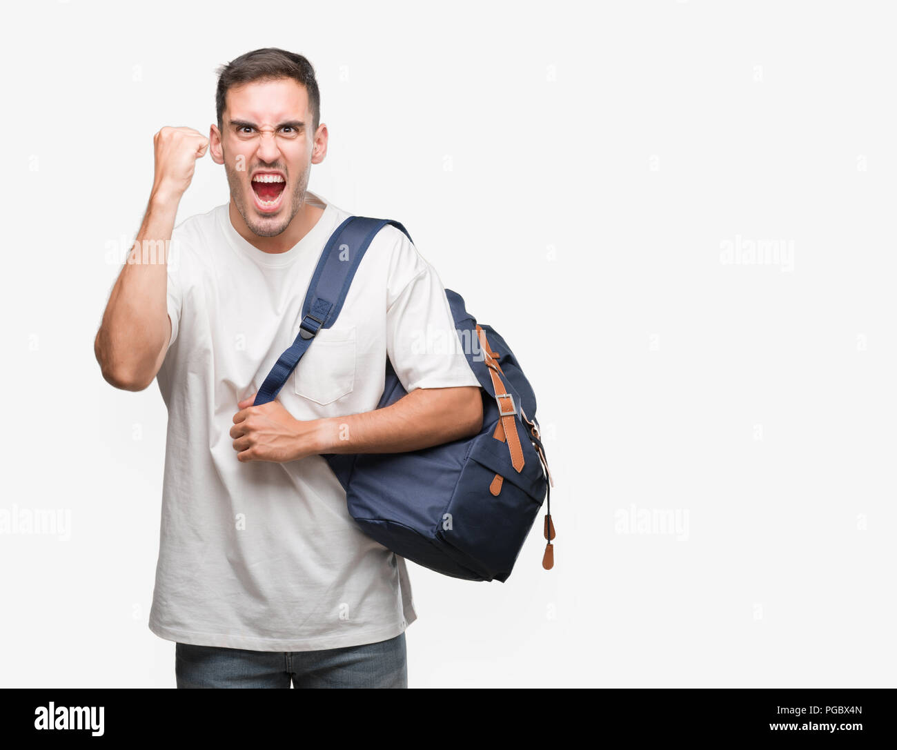 Handsome young man holding backpack annoyed and frustrated shouting ...