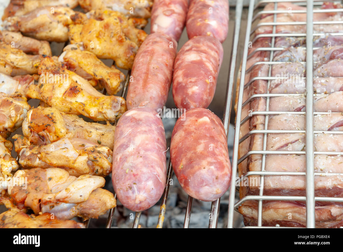 Delicious seasoned barbecue meats on charcoal fire Stock Photo - Alamy