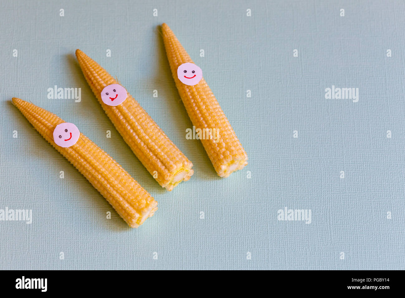 Baby corn with funny faces. Healthy organic food Stock Photo - Alamy