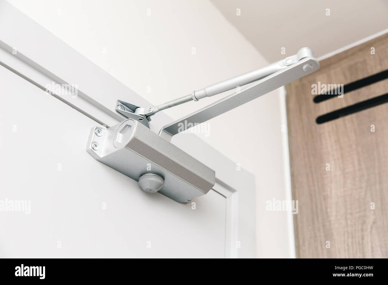 Door Closers automatic closing door device for security Stock Photo - Alamy