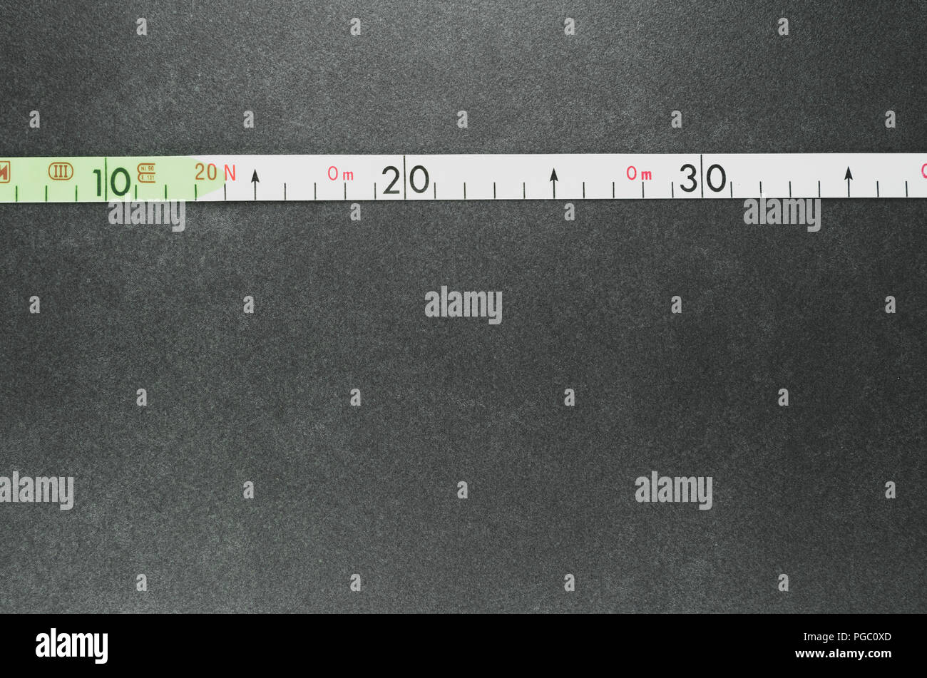 tape ruler - objects on a dark stone surface Stock Photo - Alamy