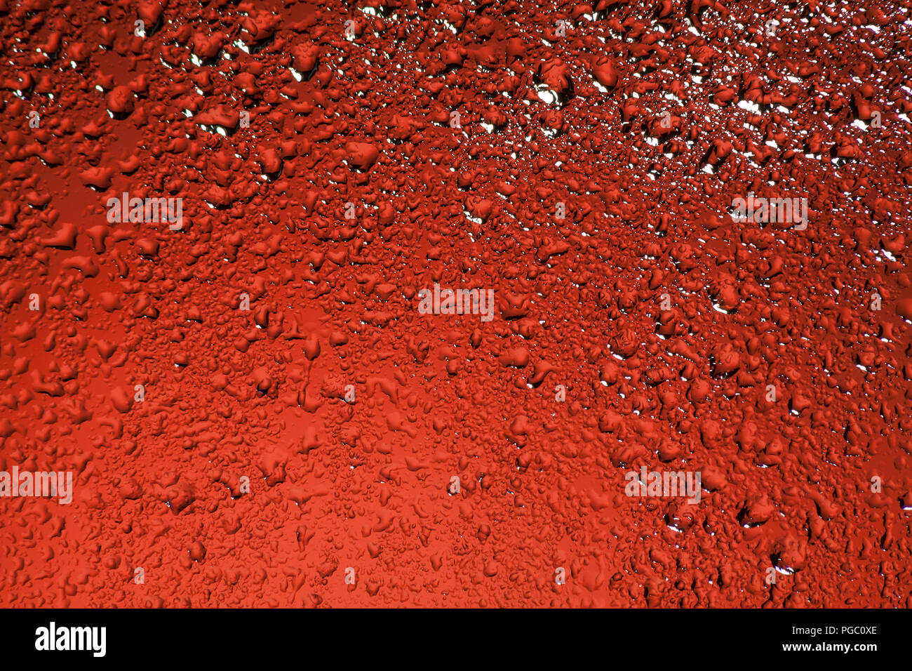 Rainy window. Drops on the glass in red back light Stock Photo - Alamy