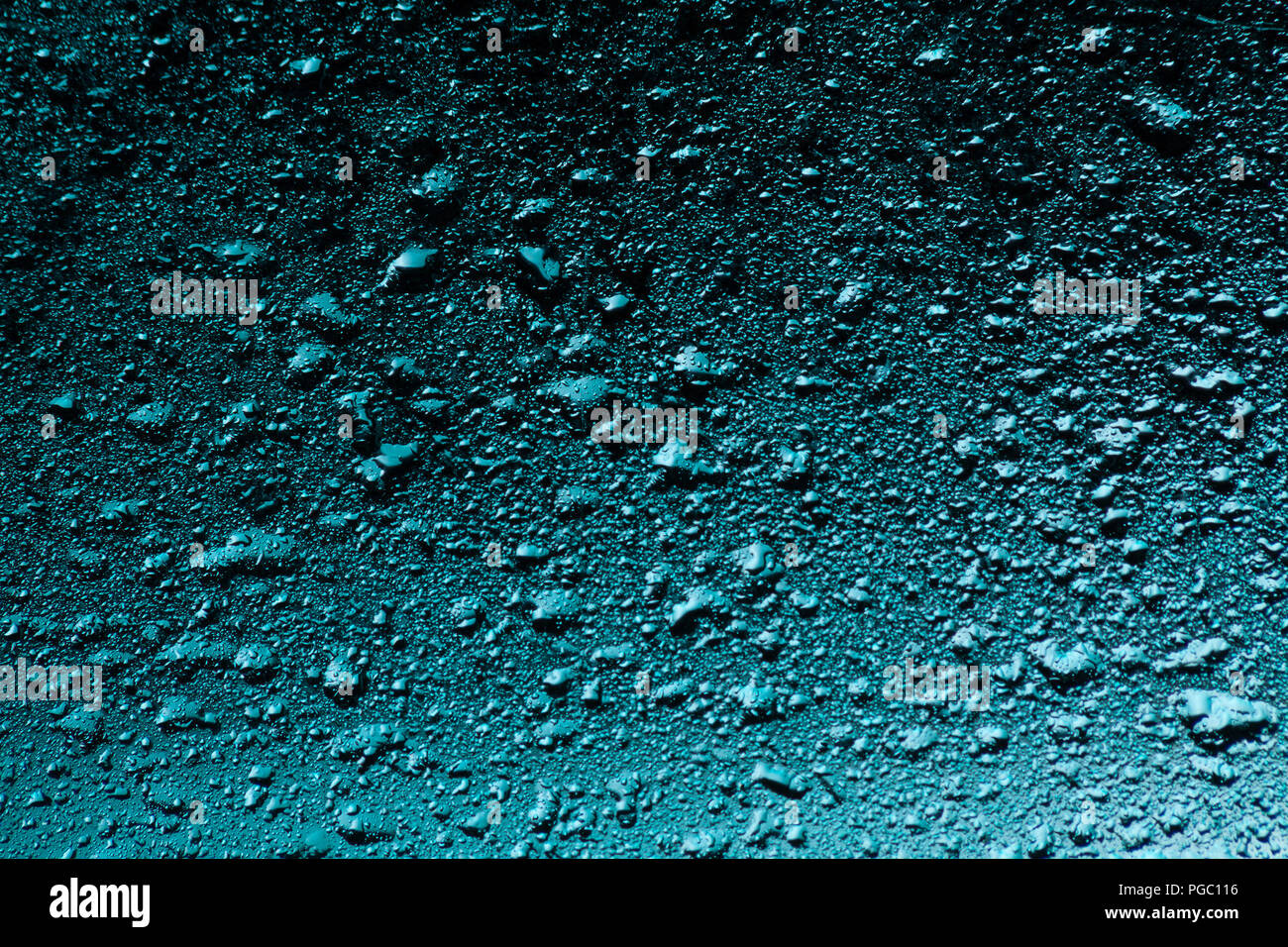 Rainy window. Drops on the glass in blue back light Stock Photo - Alamy