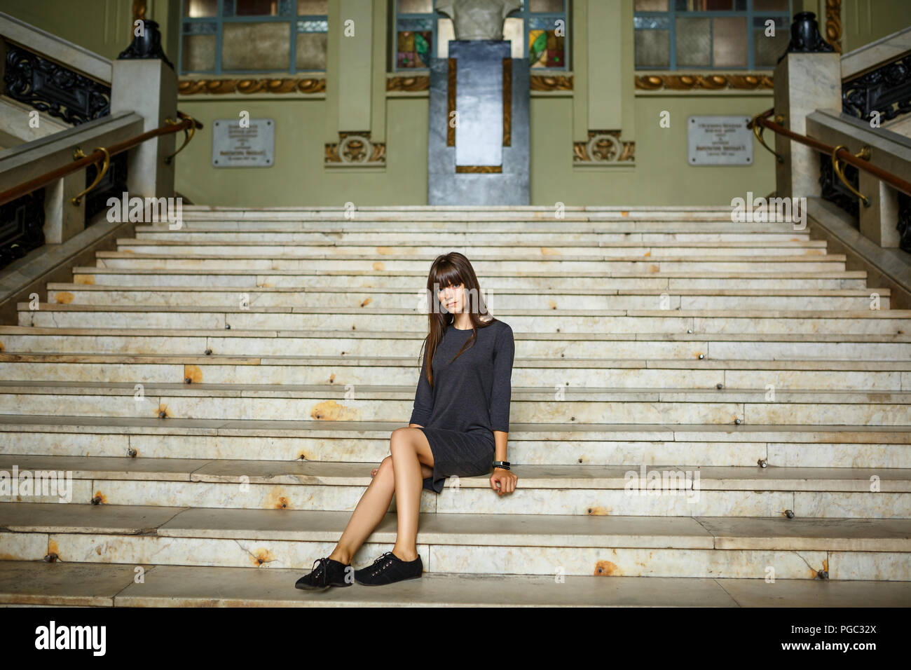beautiful young woman sitting on the steps Stock Photo - Alamy