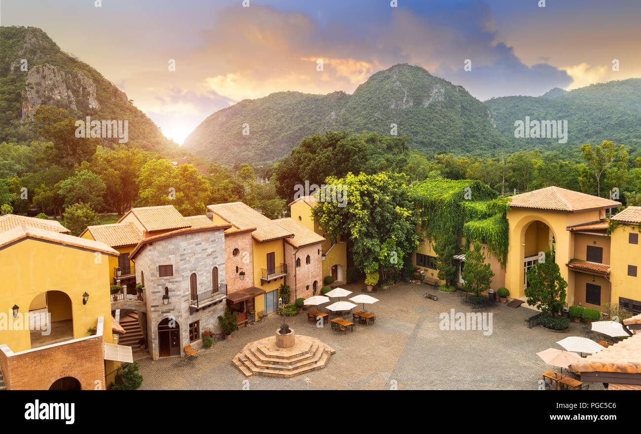 Mountain view and old Italian village style building in morning sun ...