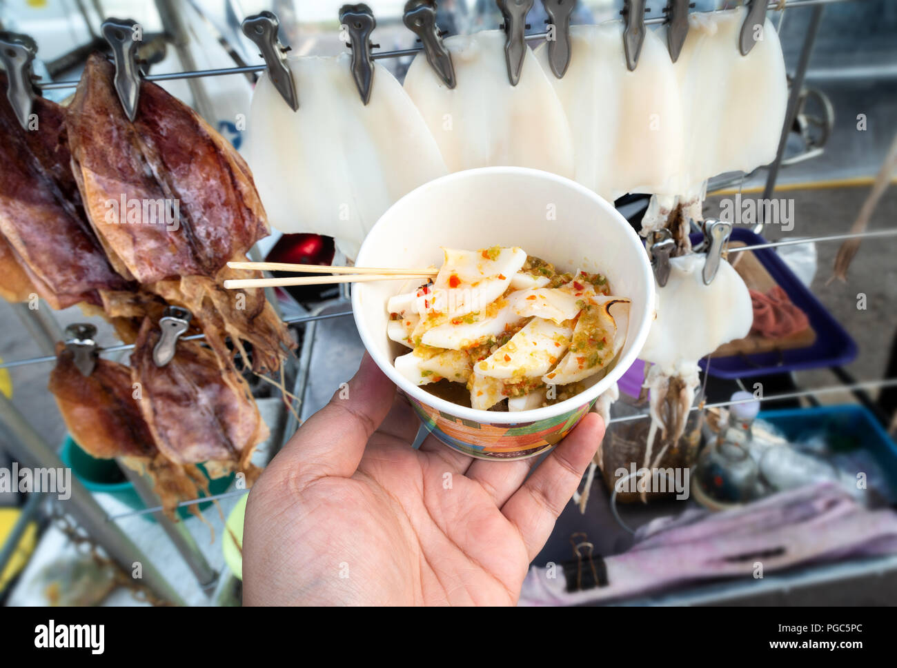 Grilled spicy squid and dry out squid with clip hanging for sale Stock ...