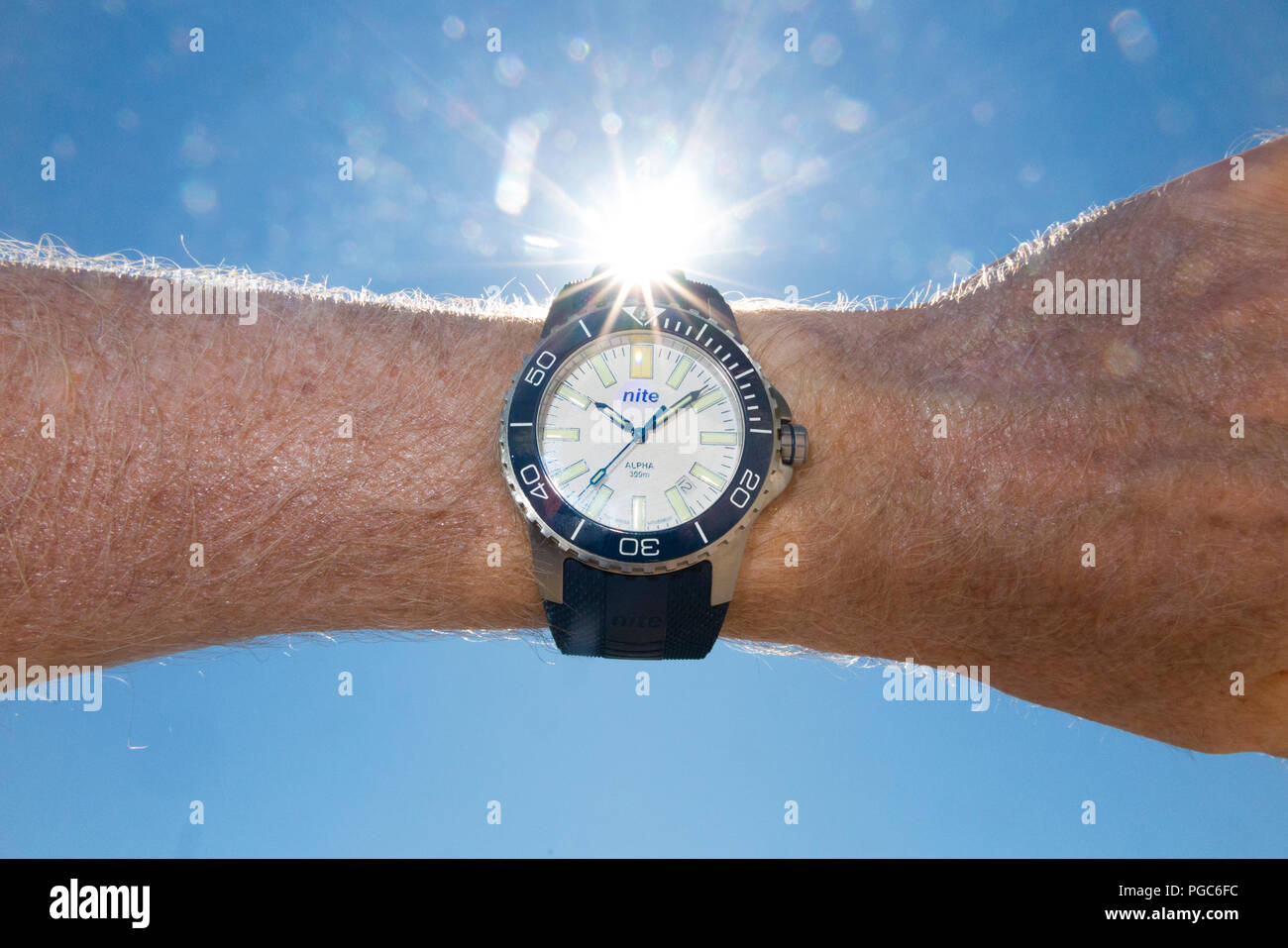 Watch made by British manufacturer Nite watches being worn on a beach ...