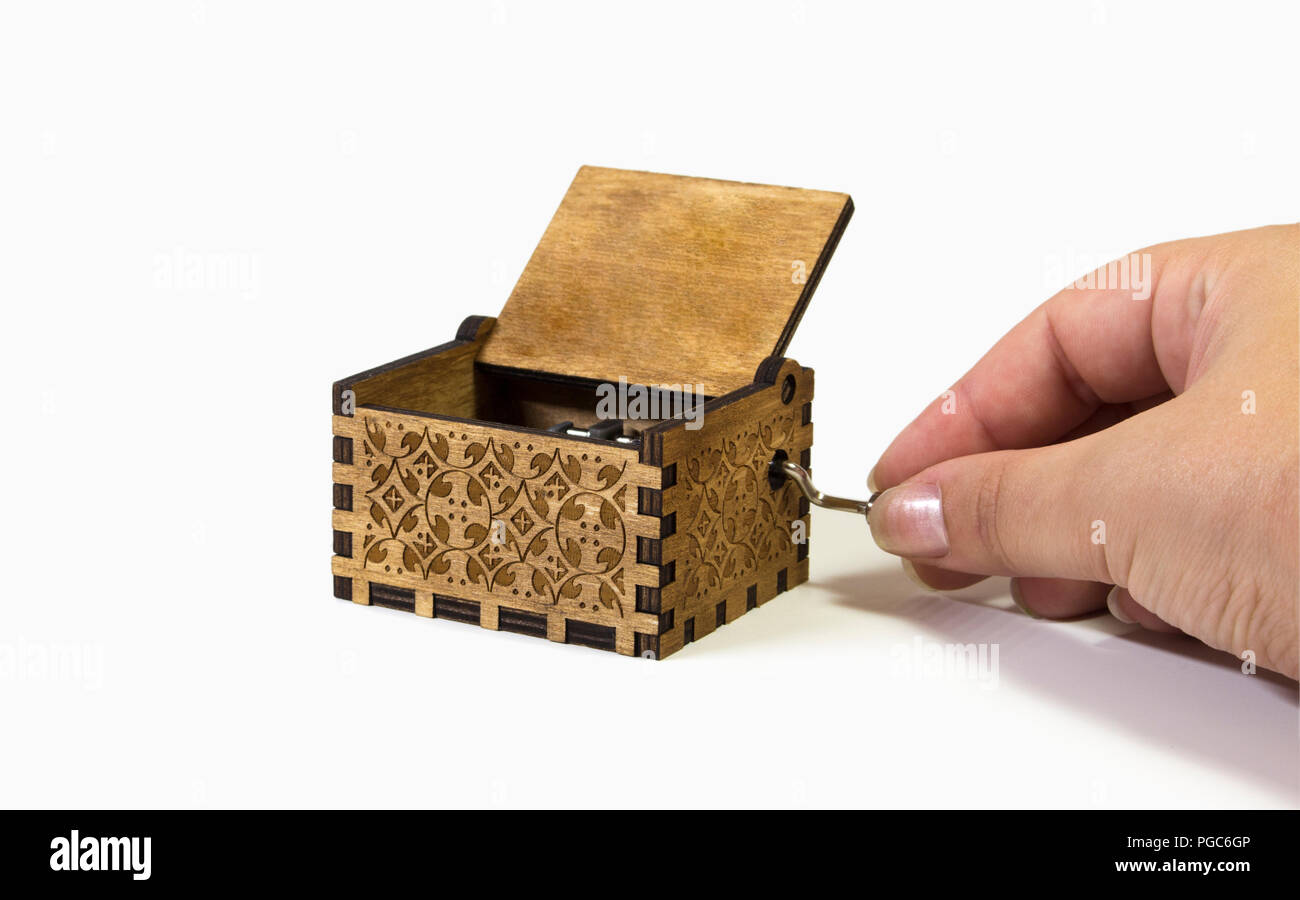 Horizontal photo of woman's hand playing a music box. Macro of the ...