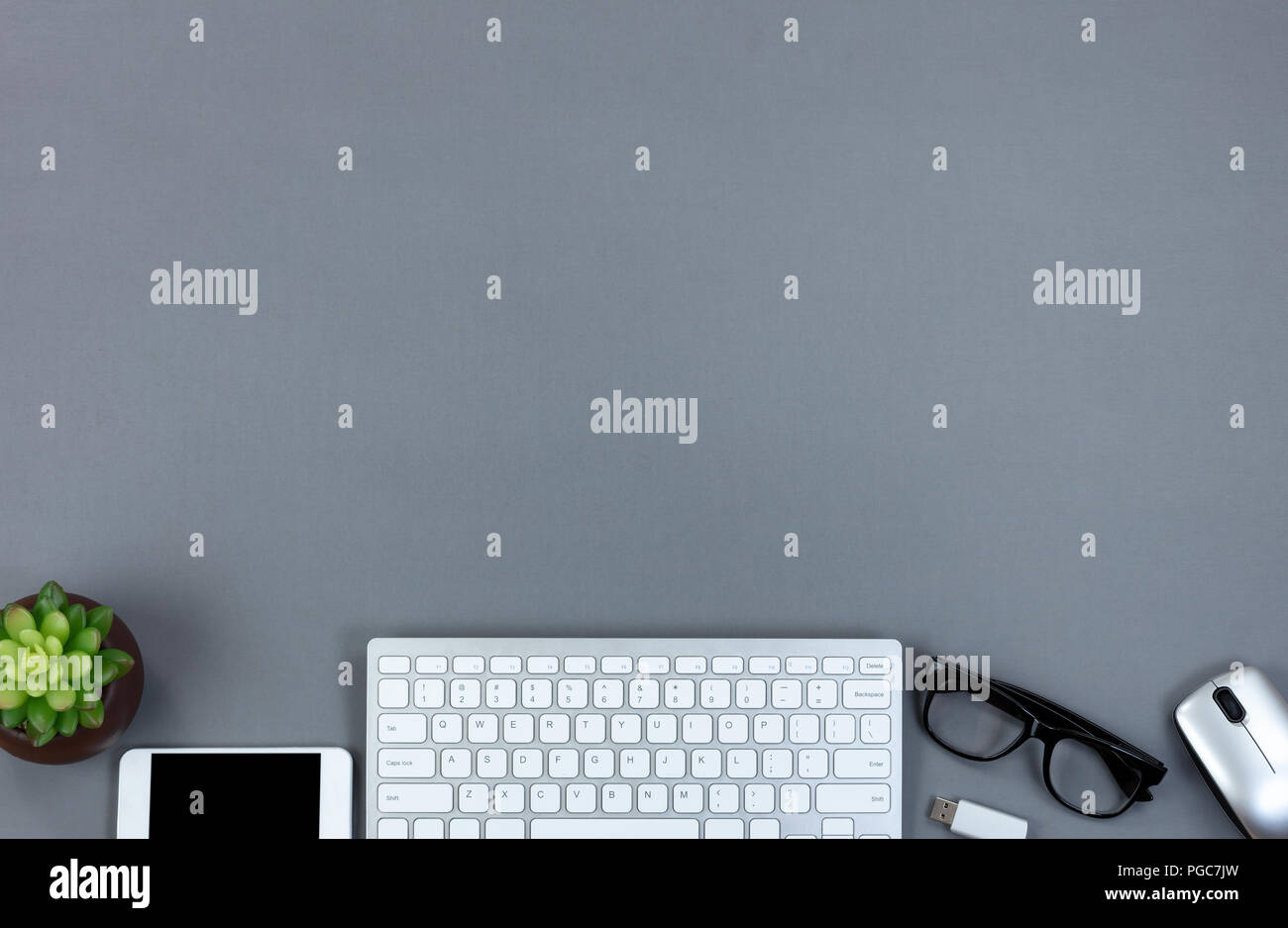 Grey office desktop with technology and copy space Stock Photo - Alamy