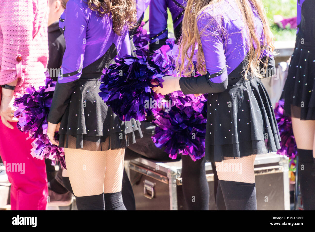 Cheerleaders in purple suits Stock Photo - Alamy