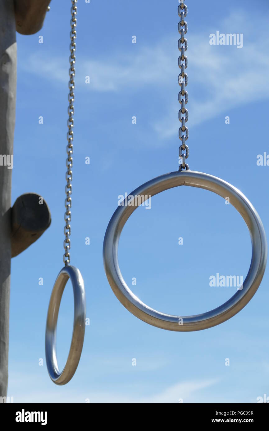 two metal rings on wooden construction in children playground Stock ...