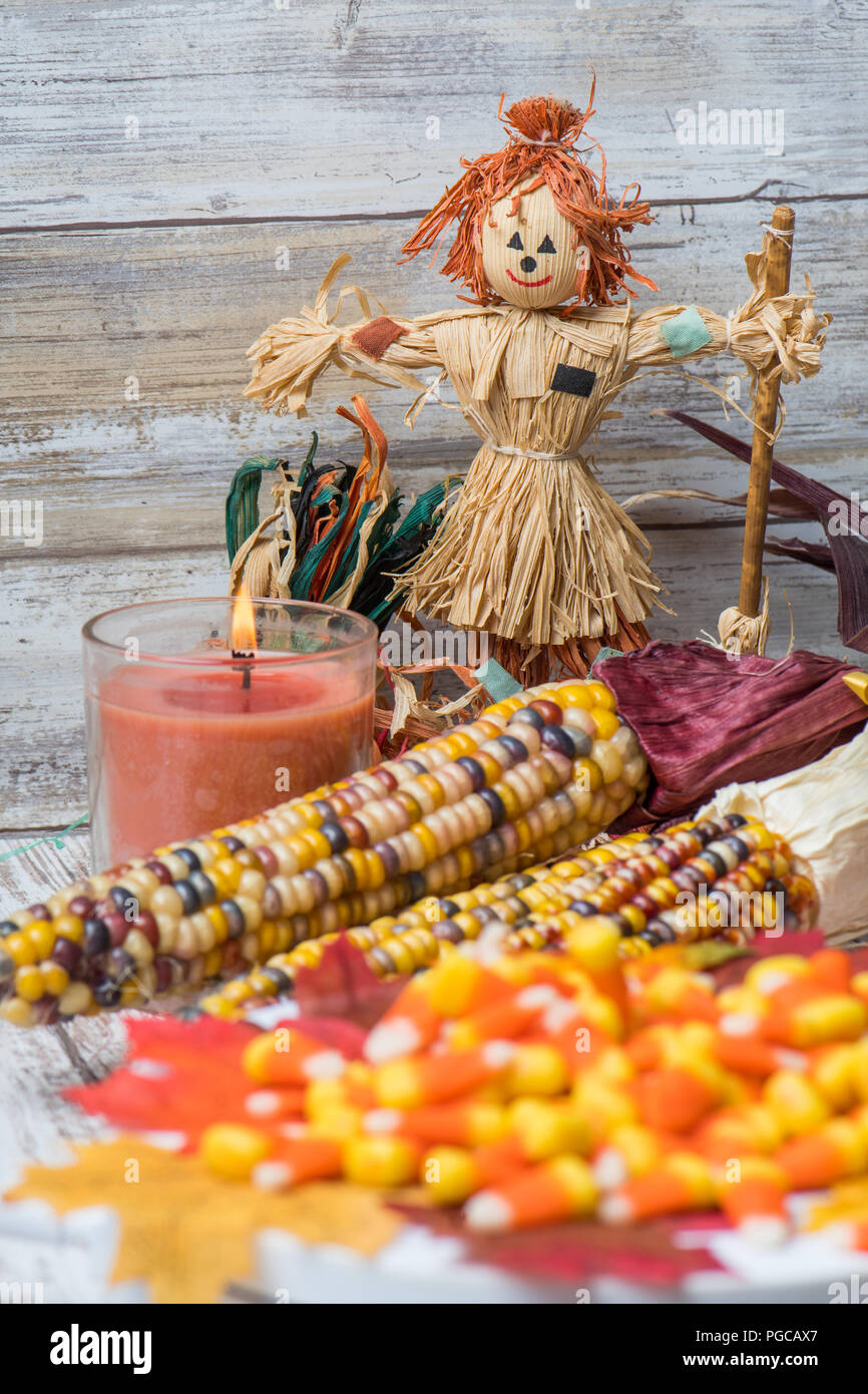 Scarecrow with candle, Indian corn and candy corn Stock Photo - Alamy