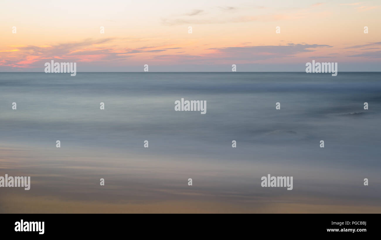 Beautiful blurry sunset at the sea on a hot, summer evening Stock Photo ...