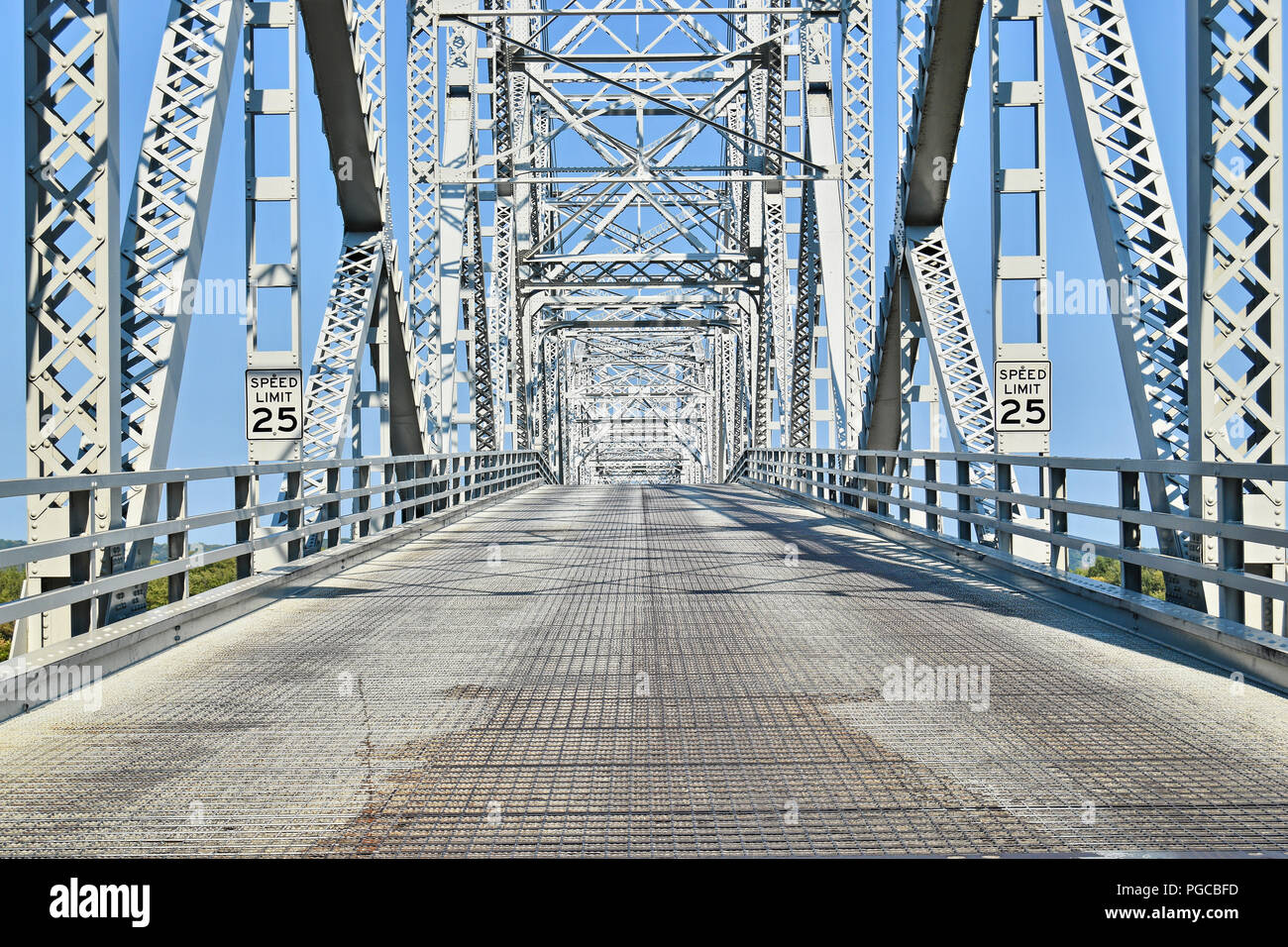 The perspective of a steel bridge crossing a river Stock Photo - Alamy