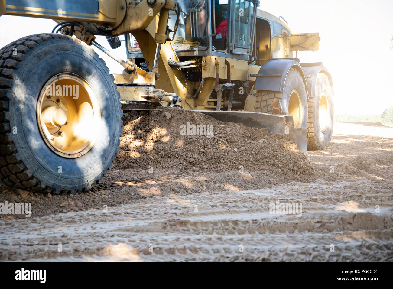 Building country road, shoveling grit with grader Stock Photo - Alamy