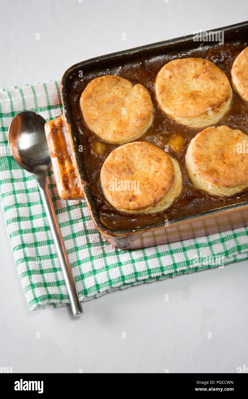 Savoury/Savory minced Beef stew topped with cheese scones in an oven ...
