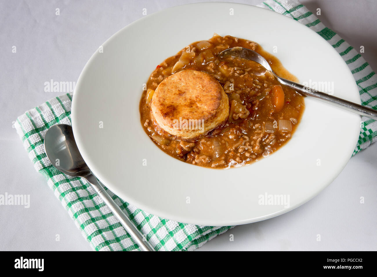 An English pub dish of beef cobbler. Savoury minced beef stew topped ...