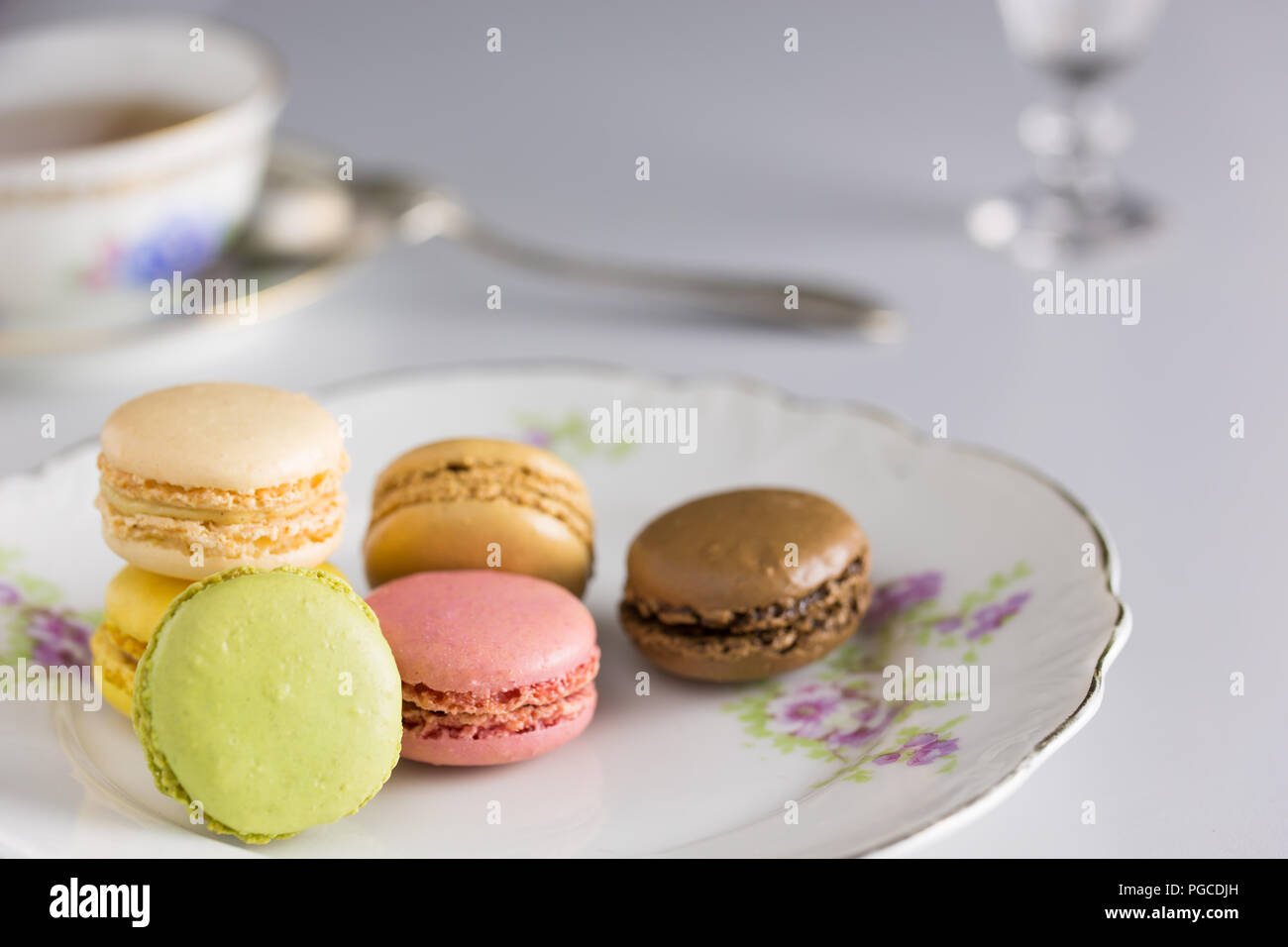Old plate with macaroons on a blurred background Stock Photo - Alamy