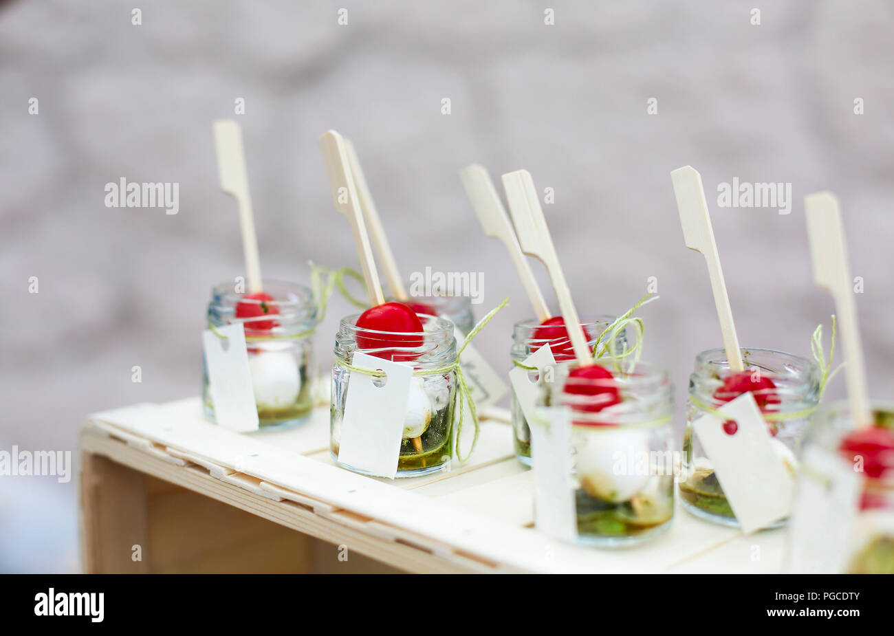 Fresh italian caprese salad with mozzarella and tomatoes in little jars ...