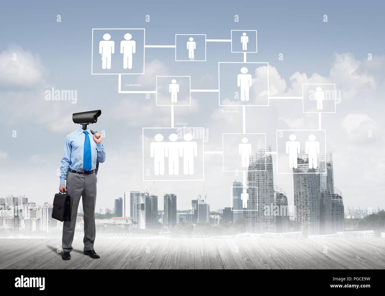 Camera headed man standing on wooden floor against modern cityscape ...