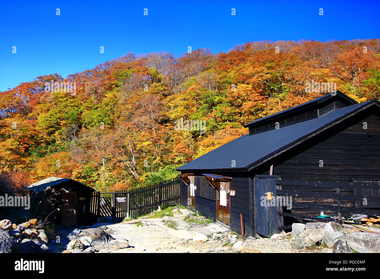 Wooden hut with open-air hot spring onsen (Rotenburo) surrounding with ...