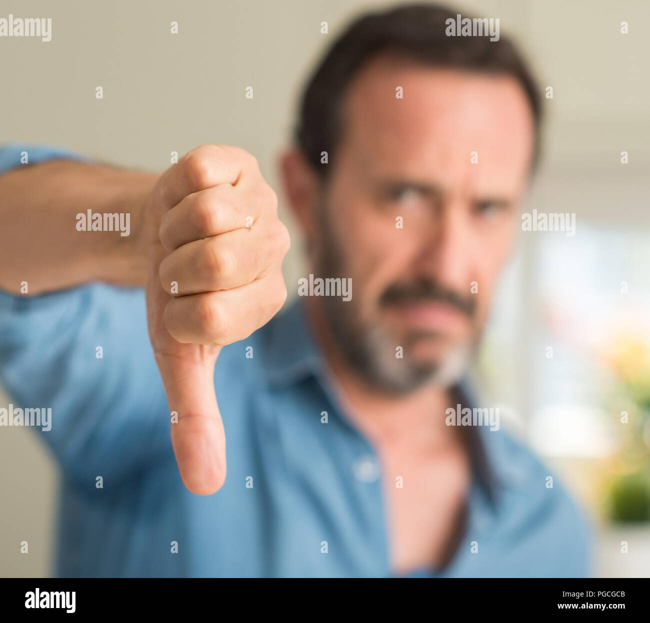 Handsome middle age man with angry face, negative sign showing dislike ...