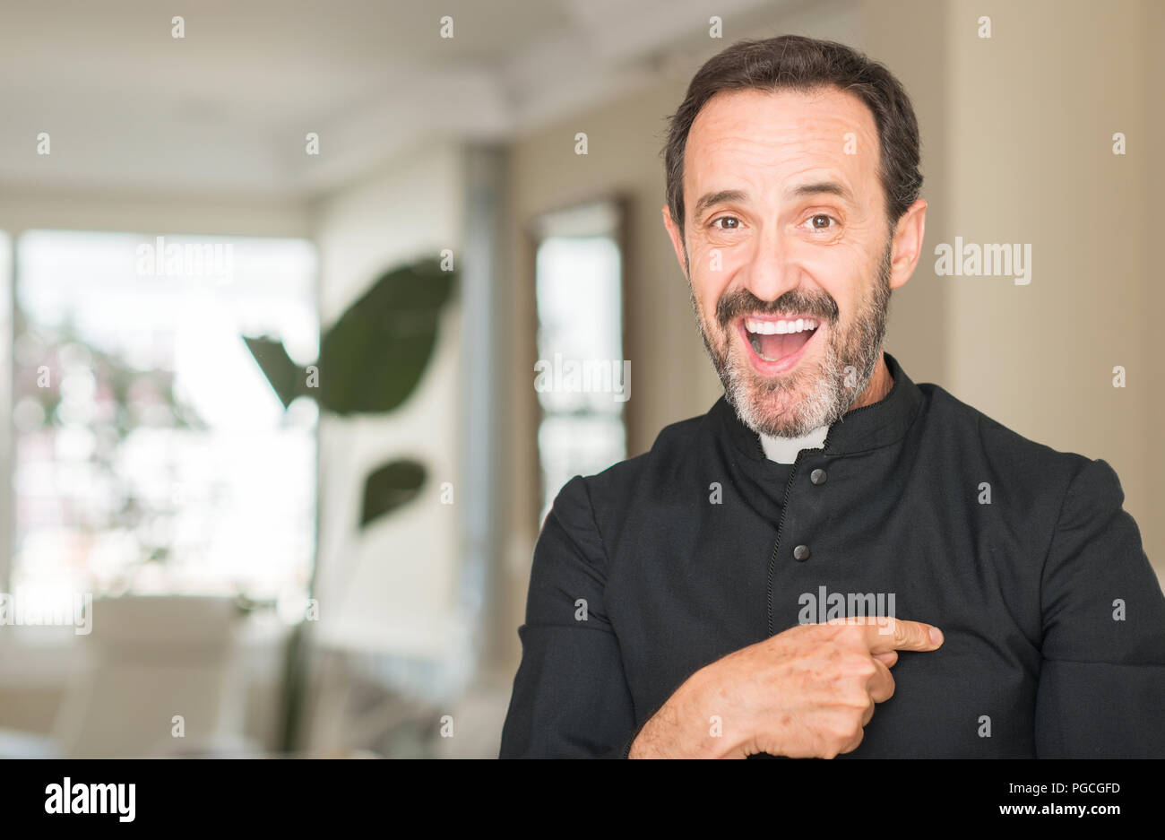 Christian priest man with surprise face pointing finger to himself ...