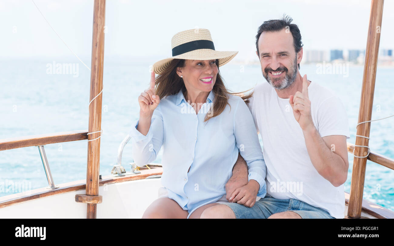 Middle age couple traveling on sailboat surprised with an idea or ...