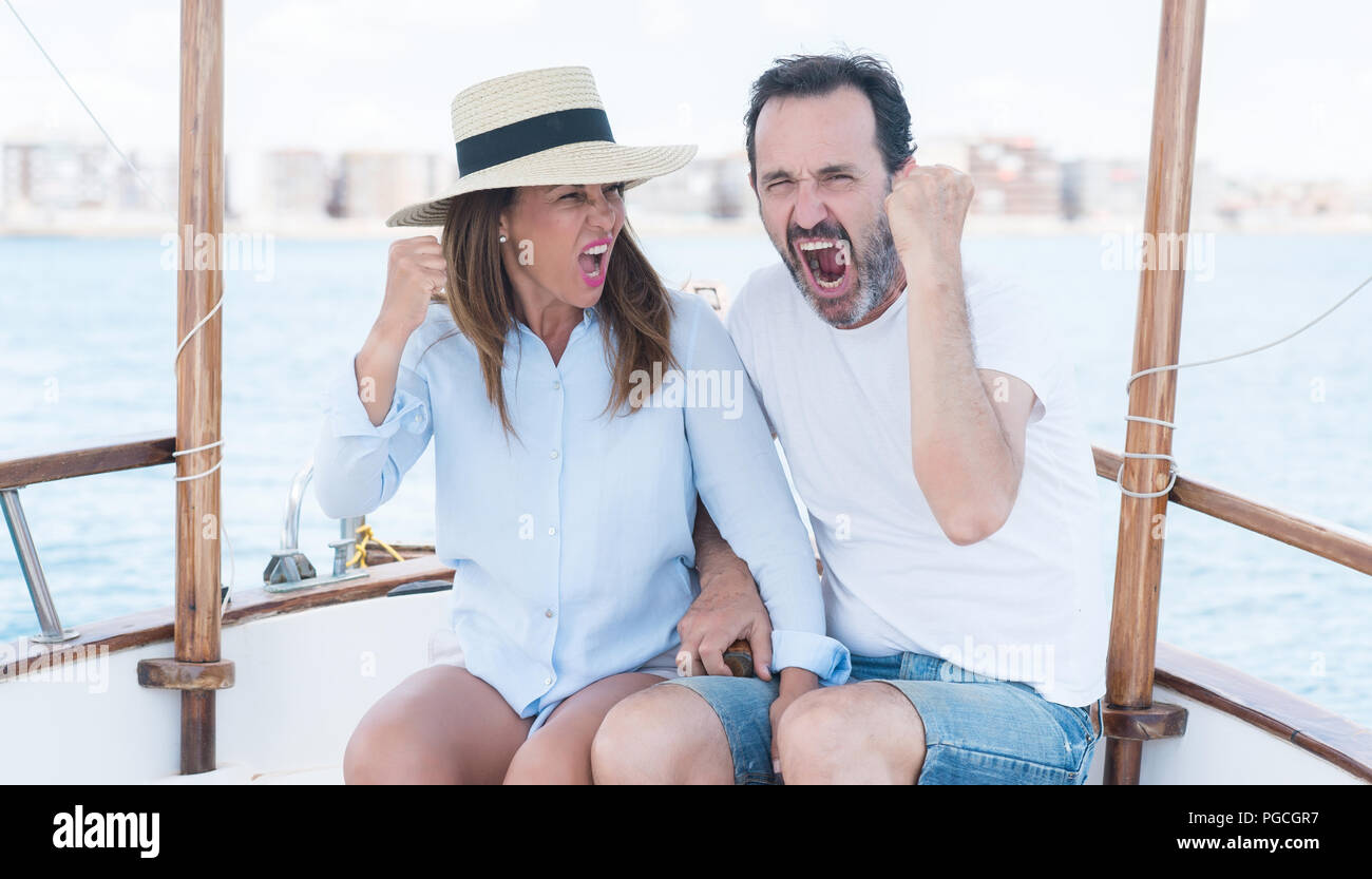 Middle age couple traveling on sailboat annoyed and frustrated shouting ...